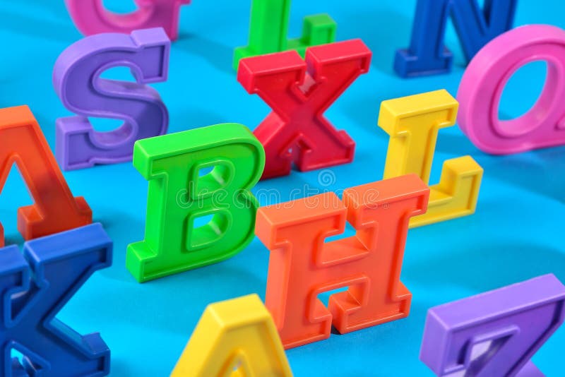 Plastic Colorful Alphabet Letters Close Up on a Blue Stock Photo ...