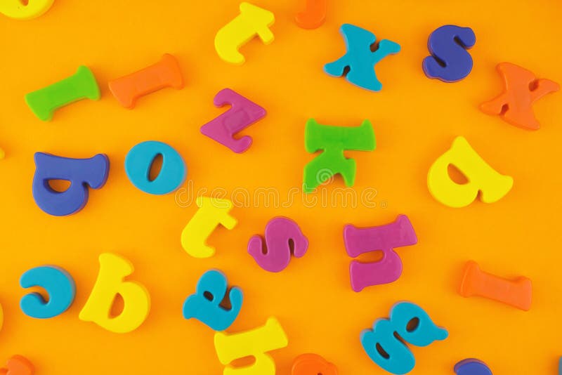 Plastic Colourful Alphabet Letters on the Orange Background Stock Photo ...