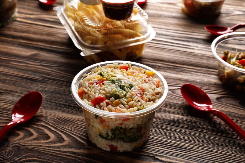 Plastic Container with Delicious Food on Wooden Table. Delivery Service ...