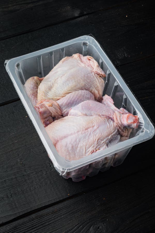 Plastic Container with Raw Chicken, on Black Wooden Table Stock Photo ...