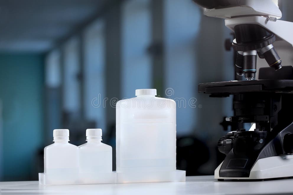 Plastic Containers in the Form of Bottles and a Microscope are on the ...