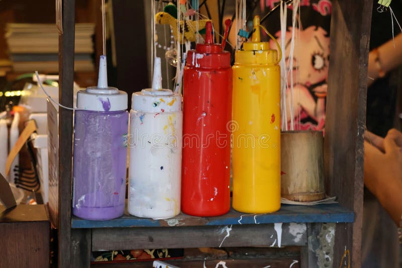 Plastic Containers of Paint for Art Work are Arranged on a Wooden Shelf ...