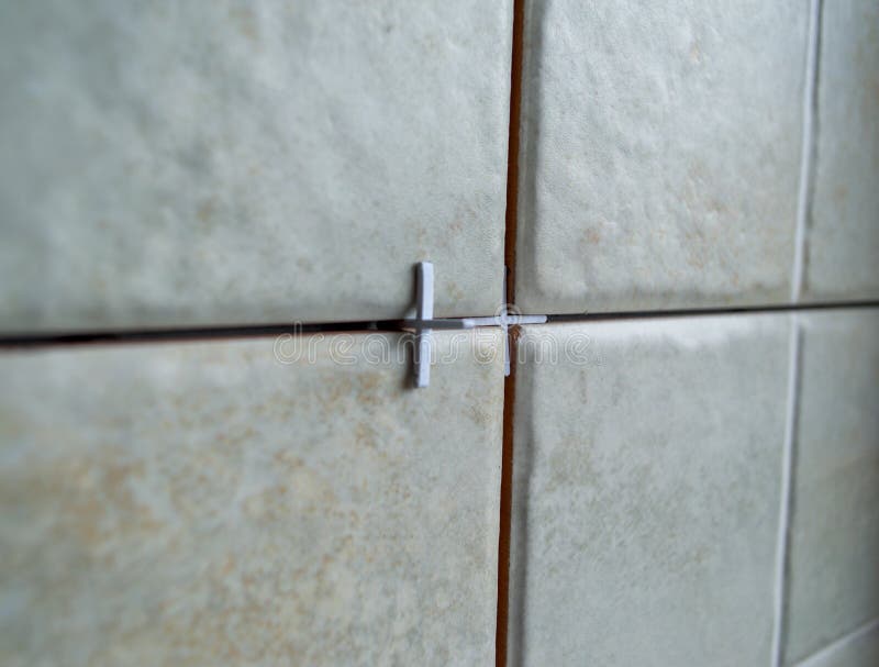 Plastic Cross for Leveling Tiles. Floor Tile Repair. Black Anc White ...