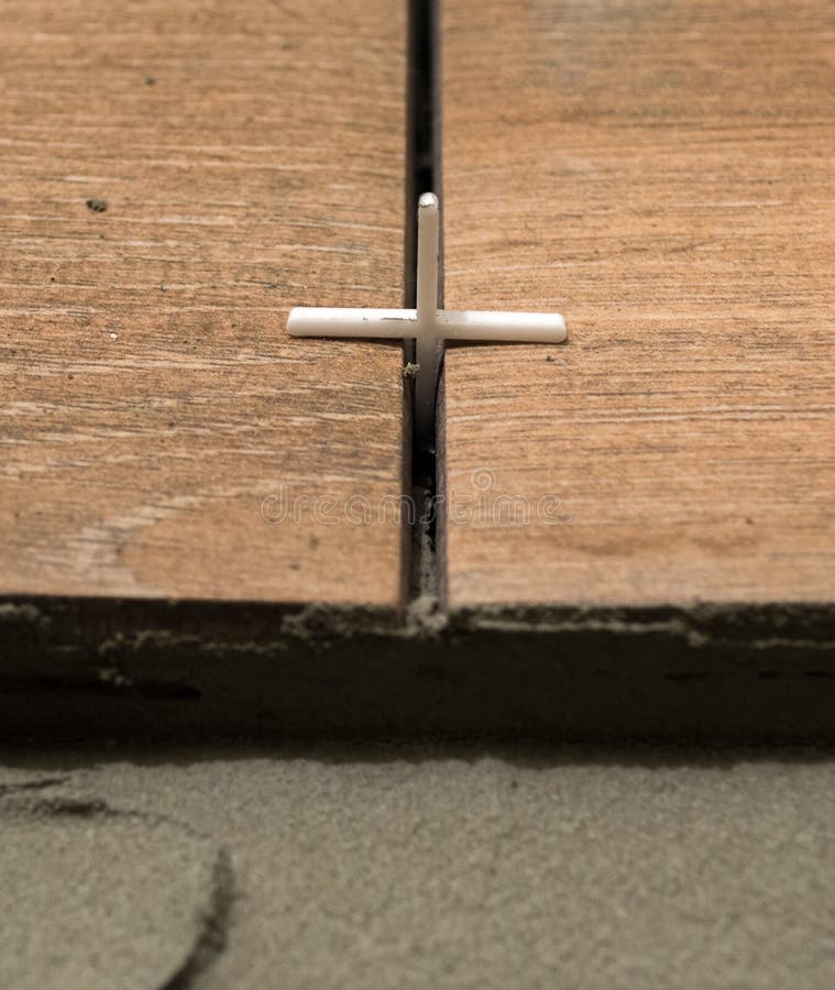 Plastic Cross for Leveling Tiles. Floor Tile Repair. Black Anc White ...