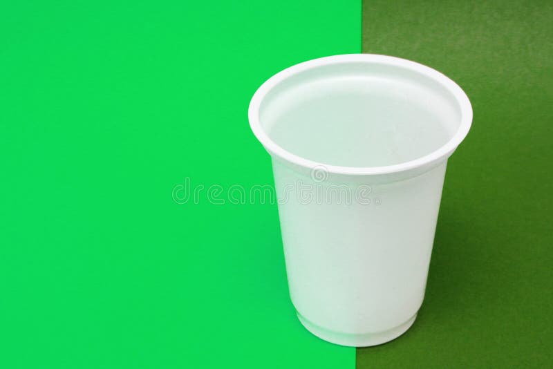 Plastic Cup on Background of Two Green Colors. Stock Photo - Image of ...