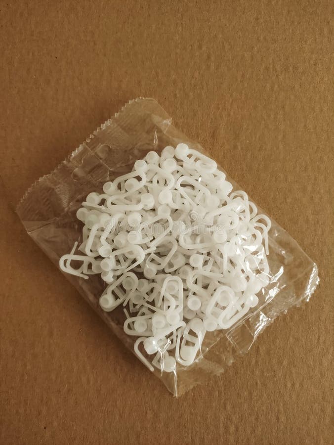 Plastic Curtain Hooks in Transparent Bag on Brown Surface Stock Image ...