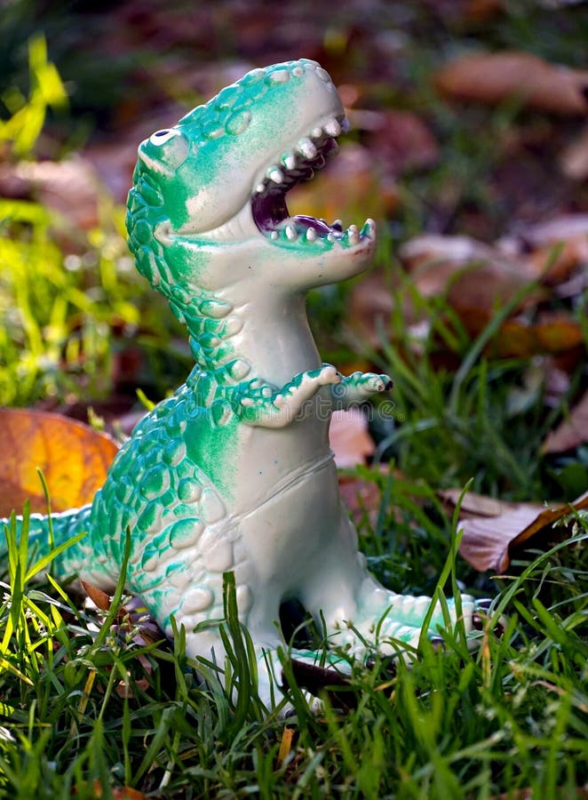 Plastic Dinosaur Toy Pictured at a Backyard Stock Photo - Image of ...