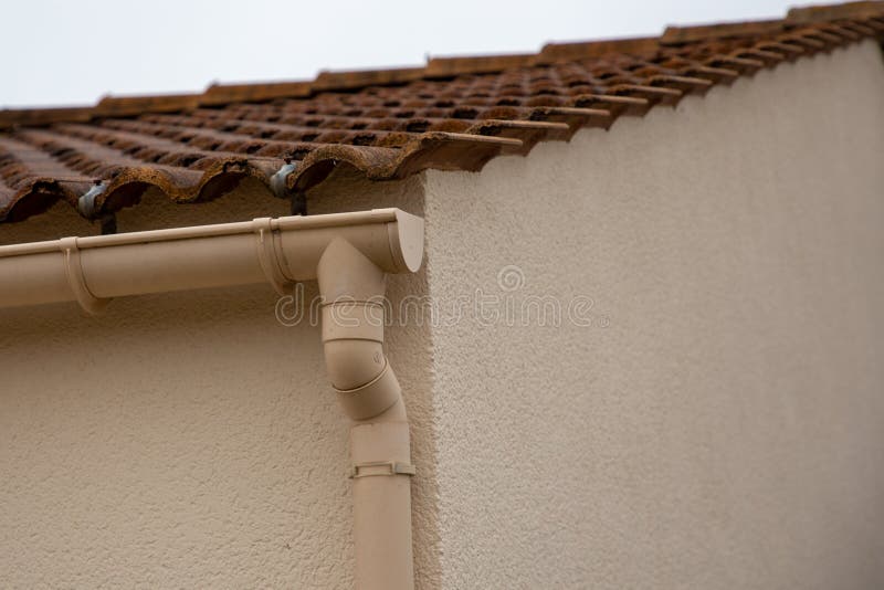 Plastic Edge of a Roof Gutter with Clips and Edge of Shingles Stock ...