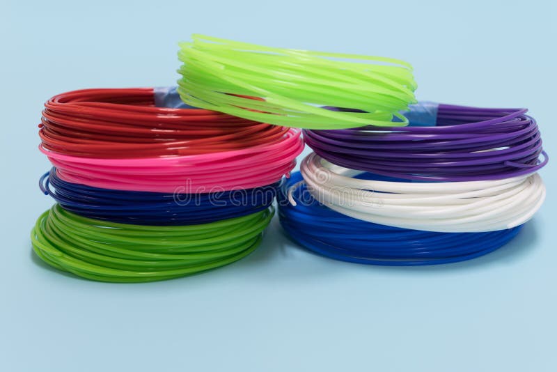 Plastic Filament of Different Colors for 3D Printing on a Blue ...