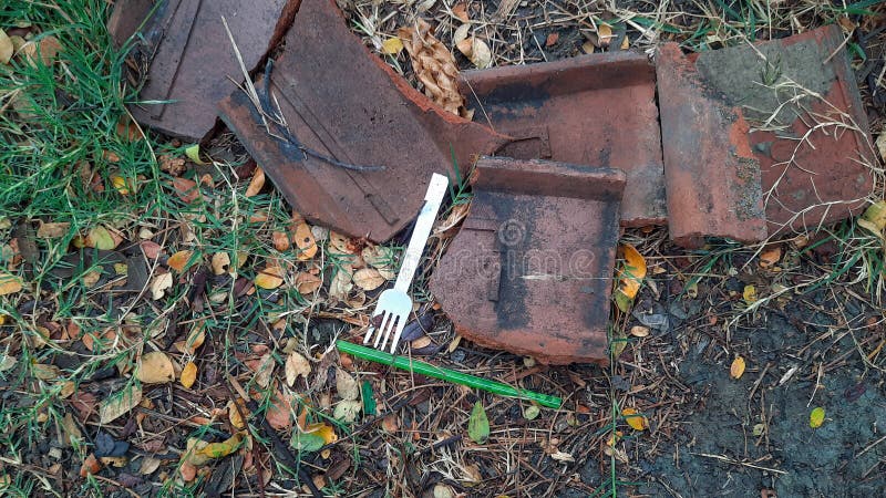 Plastic Fork and Plastic Straw Lying Down in the Ground with Old Tile ...