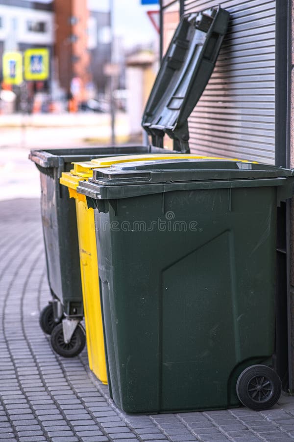 Plastic Garbage Containers on the Street of the City, Standing Against ...