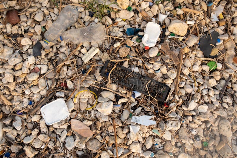 Plastic Garbage on the Seashore. Top View of a Polluted Beach. Stones ...
