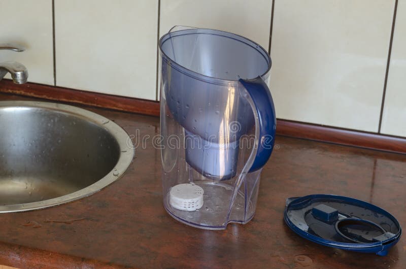 A Plastic Jug for Cleaning Water on the Kitchen Table Stock Photo ...