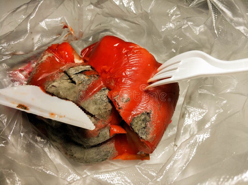 A Plastic Knife and Fork are Stuck in the Spoiled Red Pepper in the Bag ...