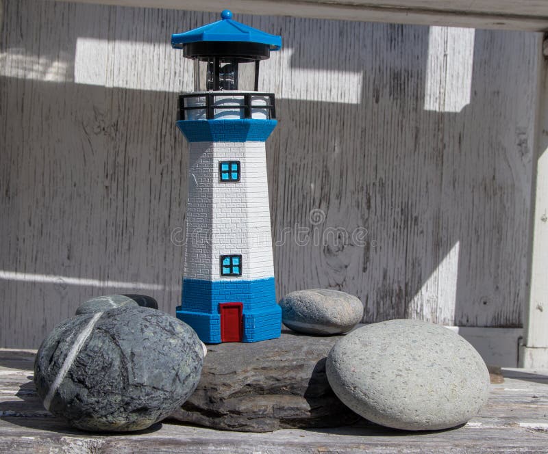 Plastic Lighthouse with Rocks at Base. Stock Photo - Image of wooden ...