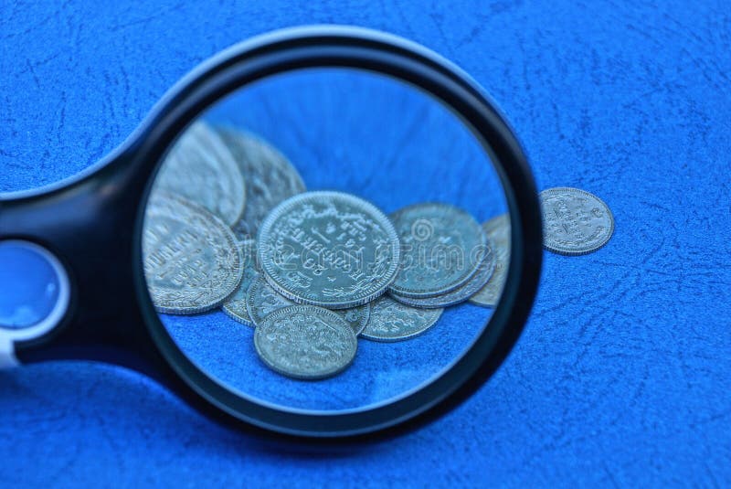 Plastic Magnifier and a Bunch of Old Silver Coins on a Blue Table Stock ...