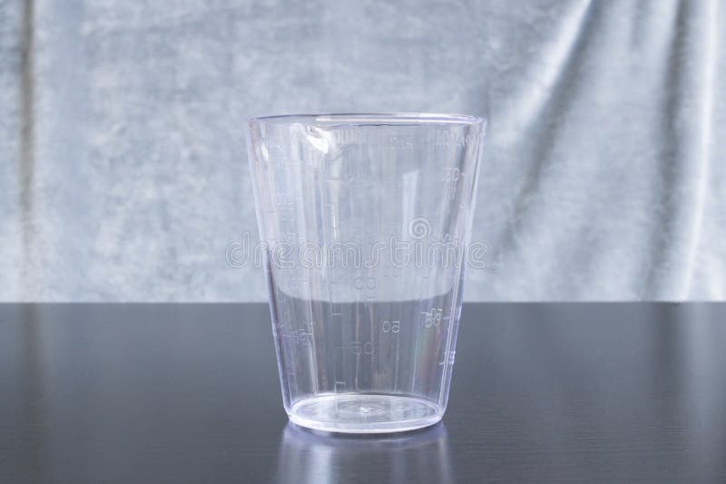 Plastic Measuring Cup on a Gray Background Stock Image - Image of ...