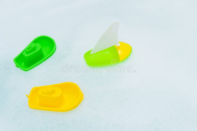 Plastic Multicolored Toy Boats on Foam Bath. Stock Photo - Image of ...