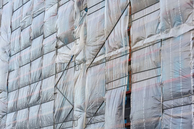Plastic Netting Covers the Scaffolding Around a Building Under ...