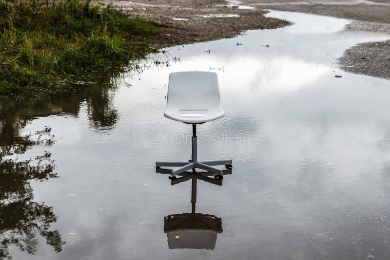 Plastic Office Chair Stands Proudly in the Center of a Huge Puddle ...