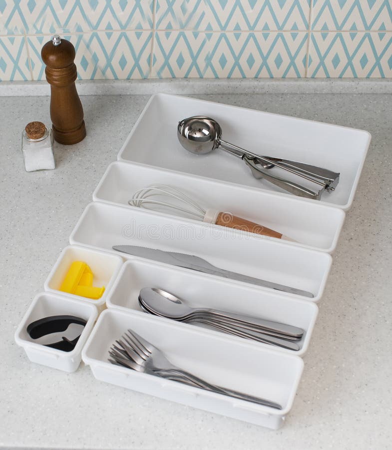 Plastic Organizer Trays with a Set of Cutlery on the Kitchen Table ...