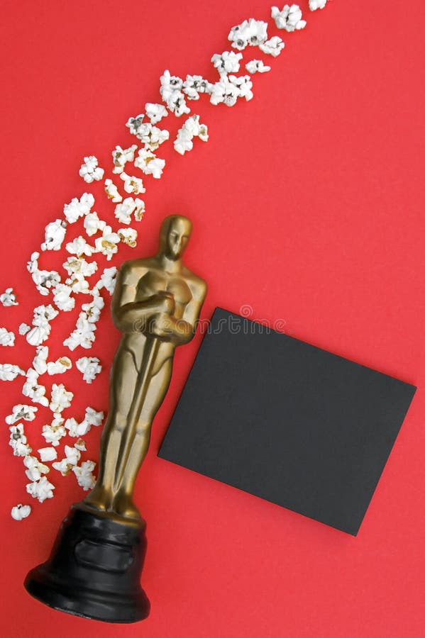 Plastic Oscar Award on a Red Background with Popcorn and a Black ...