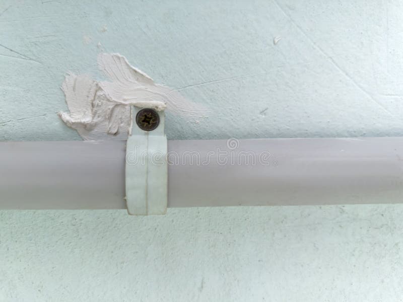 Plastic Pipe Fixed To the Wall with Plastic Pipe Clamp Stock Photo ...