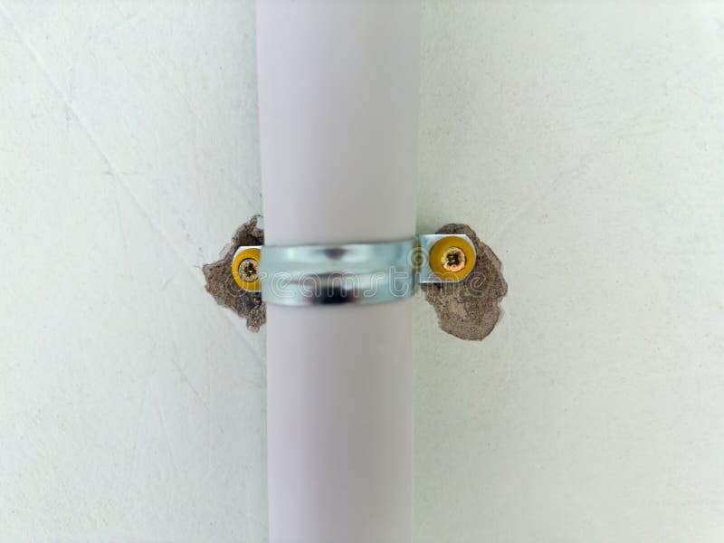 Plastic Pipe Fixed To the Wall with Metal Pipe Clamp Stock Image ...