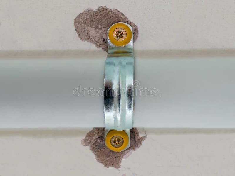 Plastic Pipe Fixed To the Wall with Metal Pipe Clamp Stock Photo ...