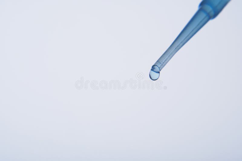 Plastic Pipette Dropping Liquid on White Stock Image - Image of ...