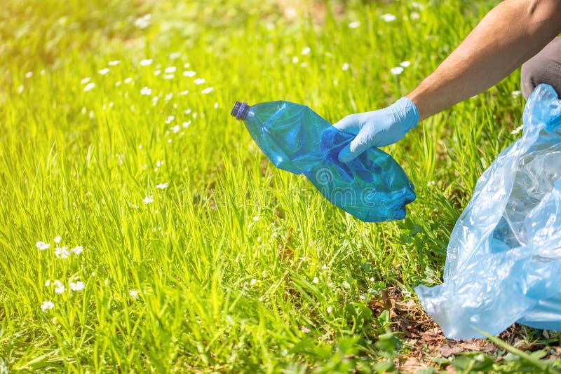 Plastic Planet, Man Picking Up Plastic Bottle, Garbage Collecting in a ...
