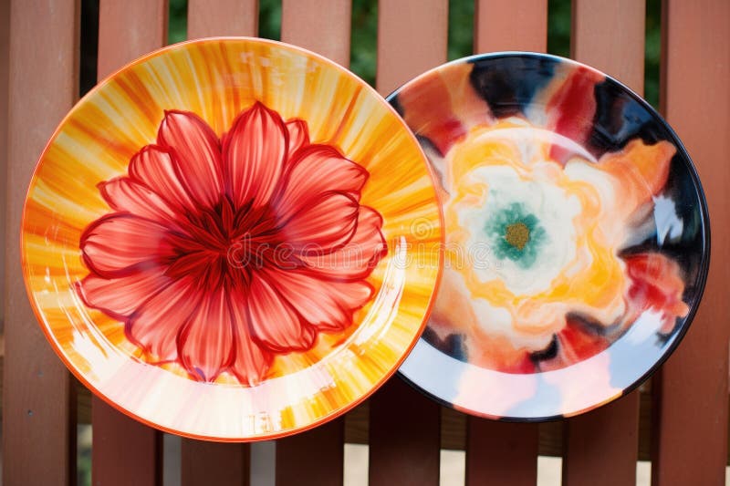 A Plastic Plate Next To a Hand-painted Ceramic Plate Stock Photo ...