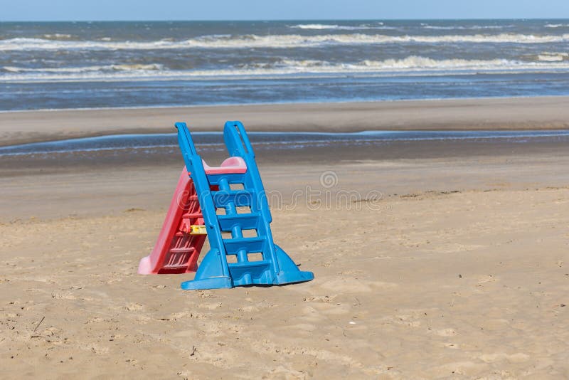 A Plastic Playground Slide on the Beach of the North Sea in Front of a ...