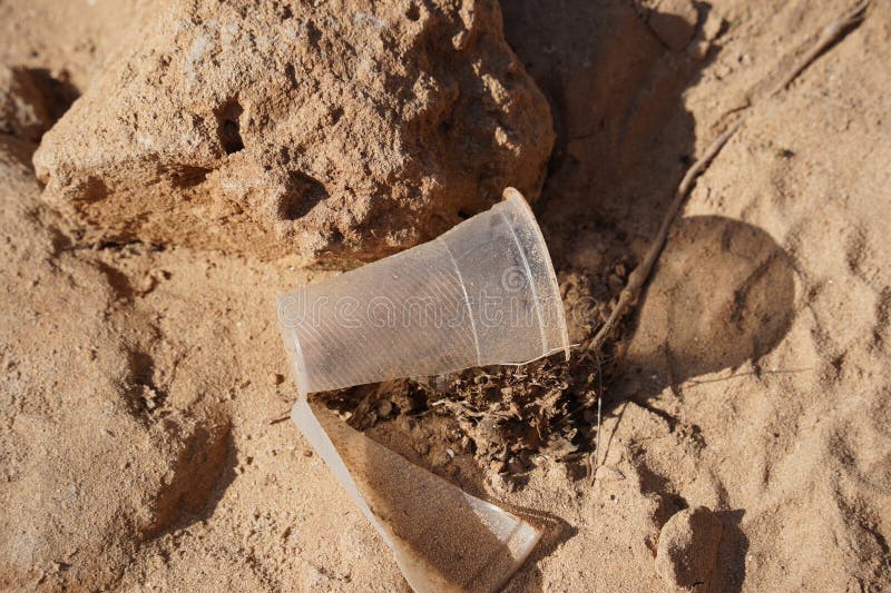 Plastic Pollution. Empty Plastic Cup on the Beach. Pollution Concept ...