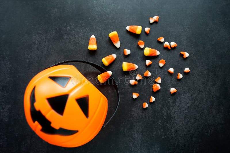Plastic Pumpkin Basket with Candy Corn Spilled Out. Some of it are ...