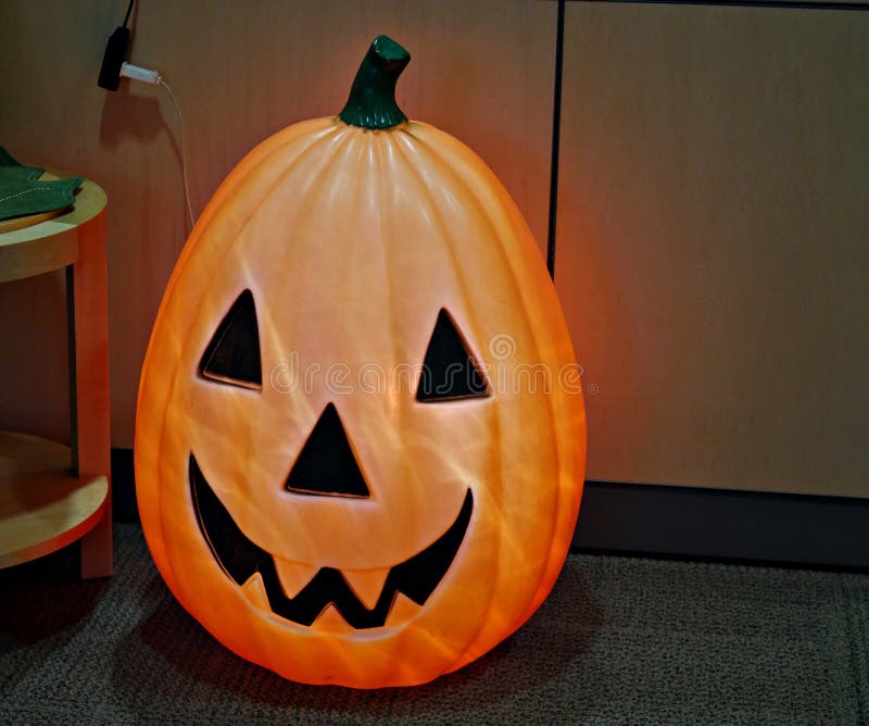 Plastic Pumpkin Lighted Up and Carved for Halloween Stock Image - Image ...