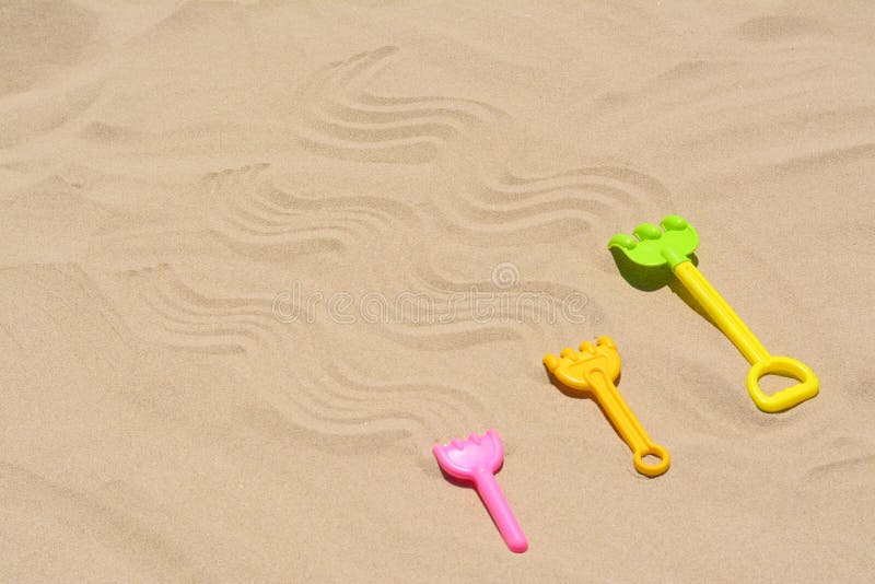 Plastic Rakes on Sand, Space for Text. Beach Toys Stock Image - Image ...