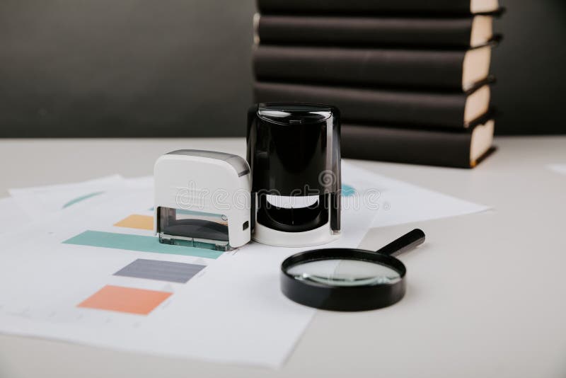 A Plastic Rubber Stamp and Charts on a Wooden Desk. Office Accessories ...