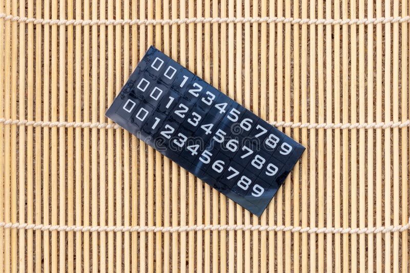 Plastic Rubber Sticker Numbers from 0 To 9 List on a Bamboo Background ...
