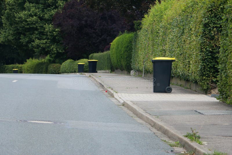 A Plastic Rubbish Bins Stand in a Row on the Side of the Road Stock ...