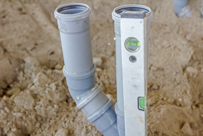 Plastic Sewer Pipe are Leveling with Level Tool on a Construction Site ...