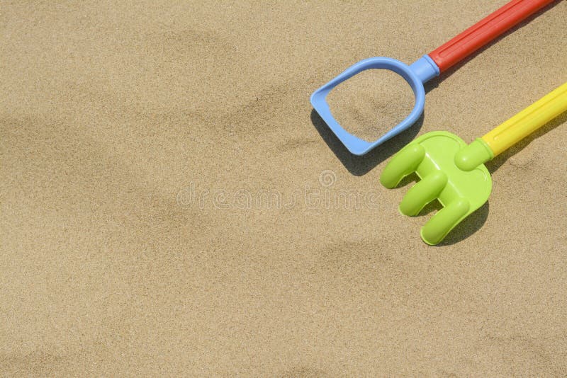 Plastic Shovel and Rake on Sand, Space for Text. Beach Toys Stock Image ...