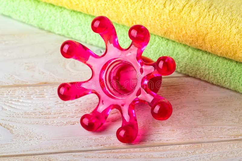 Plastic Spa Massager in the Form of an Octopus on a White Wooden ...