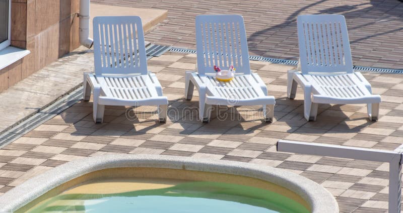 Plastic Sun Loungers by the Pool Stock Image - Image of beige, lounger ...