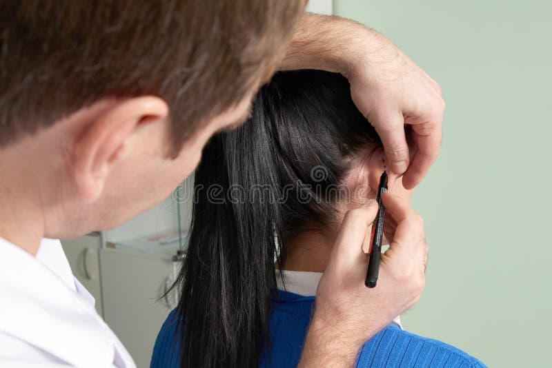 Plastic Surgeon Examines Ear of Patient before Plastic Surgery Stock ...
