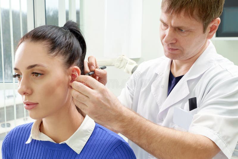 Plastic Surgeon Examines Ear of Patient before Plastic Surgery Stock ...