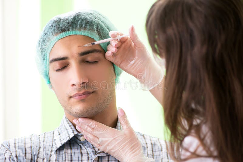 The Plastic Surgeon Preparing for Operation on Man Face Stock Image ...