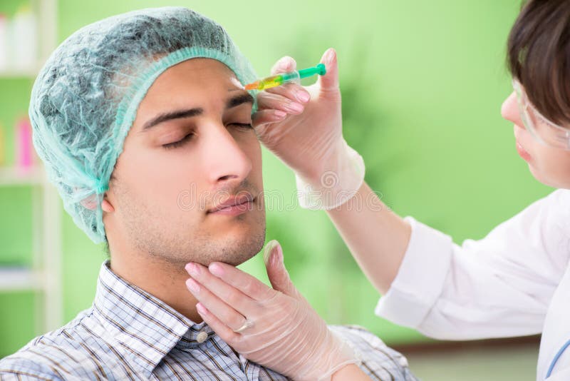 The Plastic Surgeon Preparing for Operation on Man Face Stock Photo ...