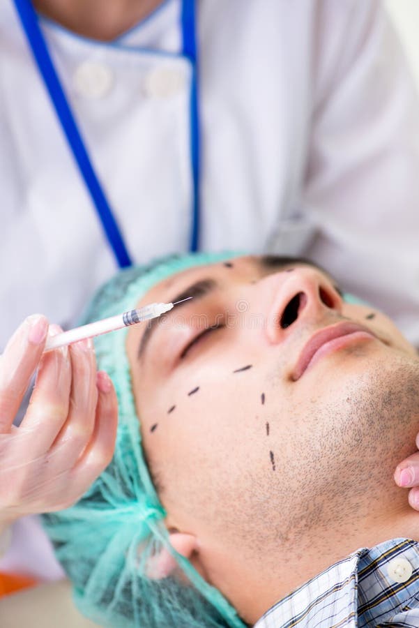 The Plastic Surgeon Preparing for Operation on Man Face Stock Image ...