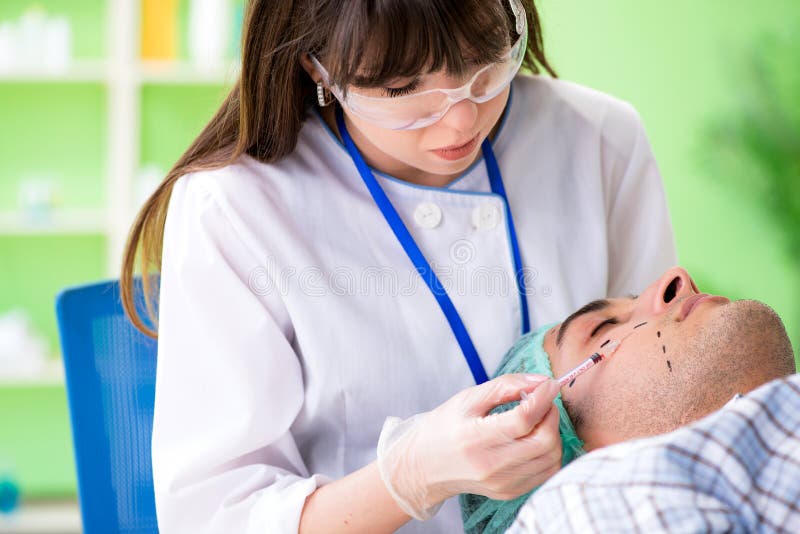 The Plastic Surgeon Preparing for Operation on Man Face Stock Photo ...